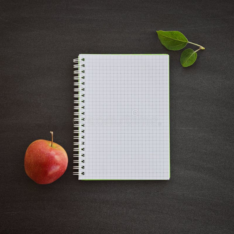 Notepad and Red Apple on Chalkboard Stock Photo - Image of empty, black ...