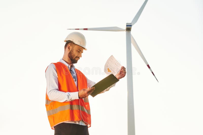 With Notepad. Service Engineer is on the Field with Windmills Stock ...