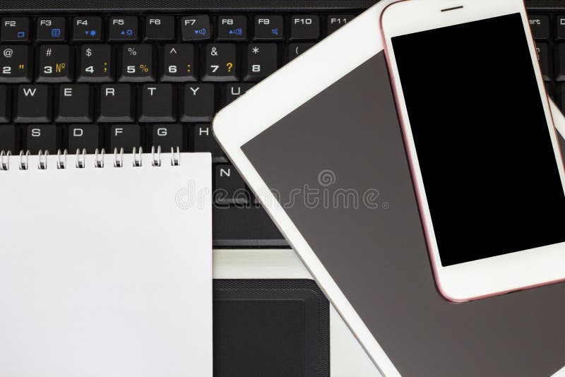 Notepad, Smartphone and Tablet on the Laptop Keyboard, Business Concept ...