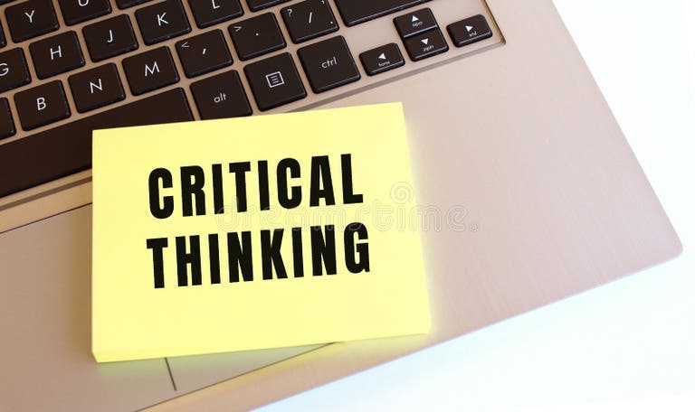 Notepad with the Text CRITICAL THINKING is on the Laptop Keyboard ...
