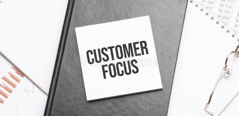Notepad with Text Customer Focus on a Charts and Numbers. Business ...