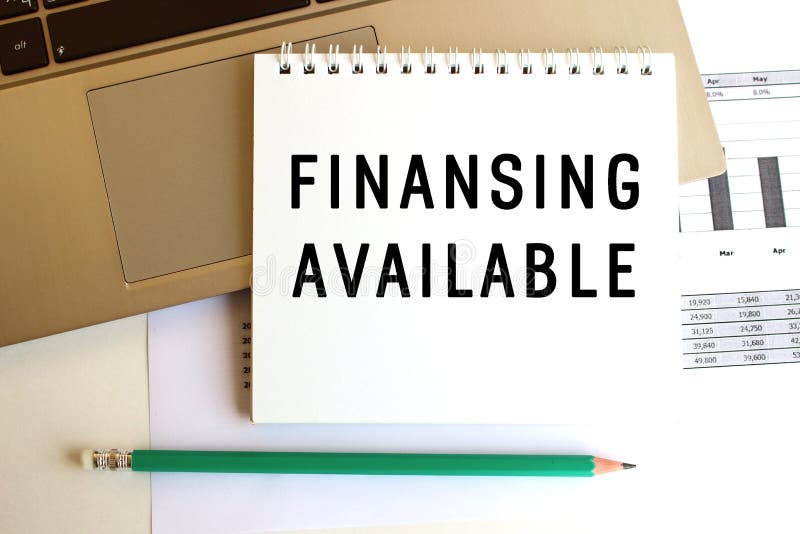 Notepad with the Text FINANSING AVAILABLE is on the Laptop Keyboard ...