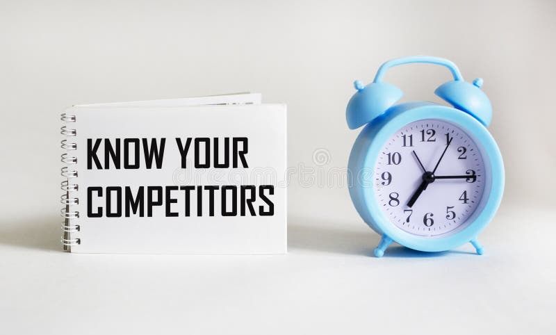 Notepad with Text KNOW YOUR COMPETITORS with Clock on White Background ... Notepad with Text KNOW YOUR COMPETITORS with Clock on White Background ...