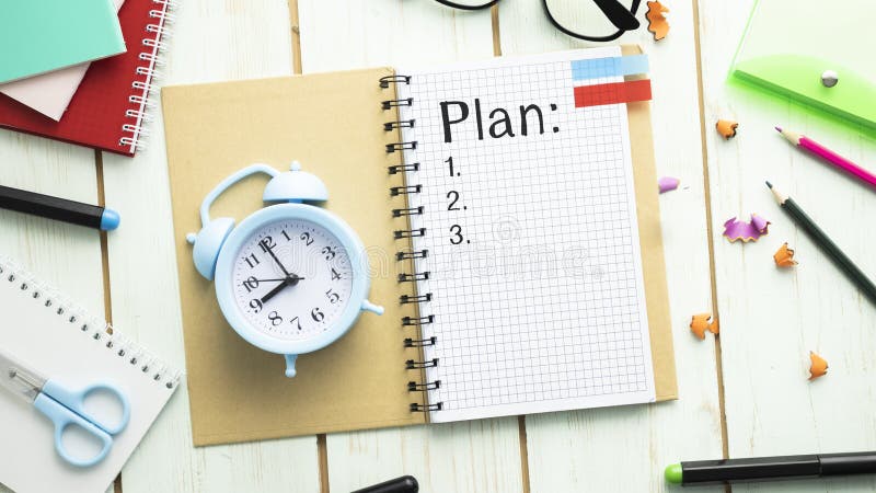 Notepad with the Text: Plan, on a Wooden Table with an Alarm Clock and ...