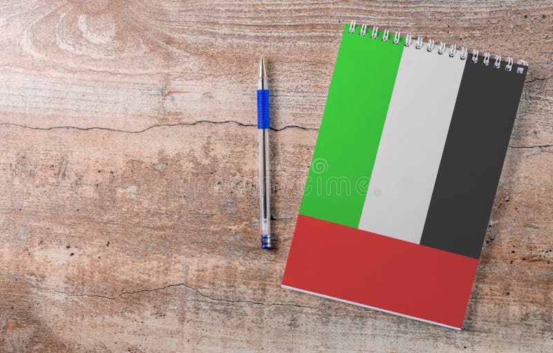Notepad with United Arab Emirates Flag, Pen on Wooden Background Stock ...