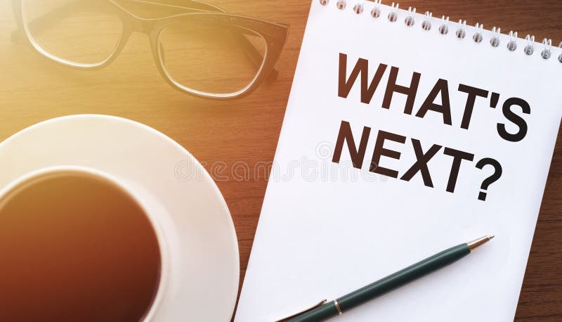 Notepad with Whats Next Written on it, Next To a Cup of Tea and Glasses ...