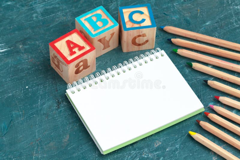 Notepad on Wooden Table and Wood Alphabet Blocks Stock Image - Image of ...