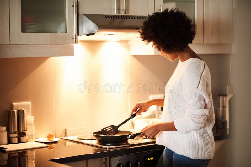 Nothing Beats a Classic Fried Egg for Breakfast. a Young Woman Cooking ...
