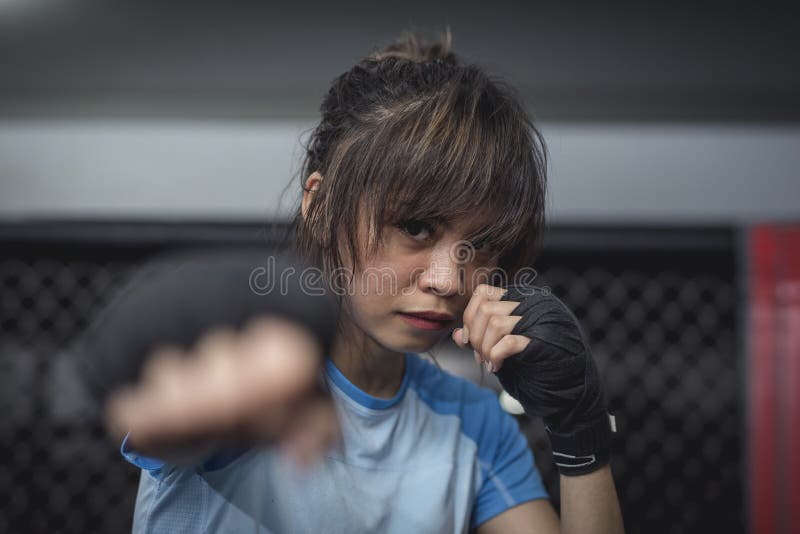 A Novice Muay Thai Trainee Poses for the Camera As she Shows the ...