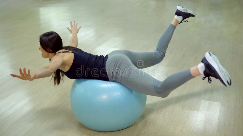 Novice In Sports Young Woman Doing Exercises With Gymnastic Ball Stock