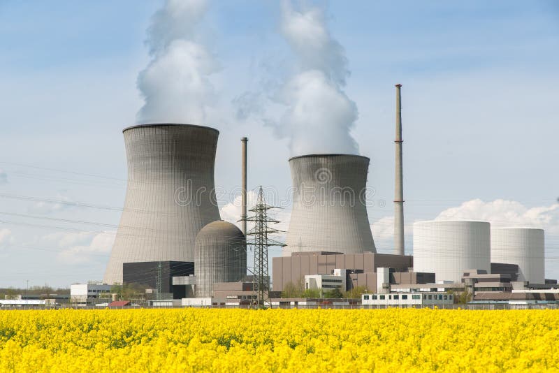 Nuclear Power Plant with Yellow Field and Big Blue Clouds. Stock Image ...