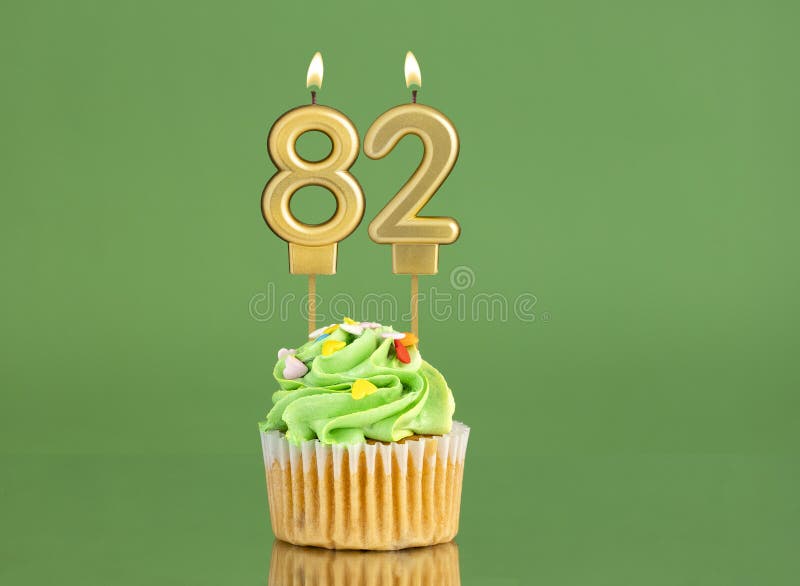 Number 82 Birthday Candle - Cupcake on a Green Background Stock Photo ...