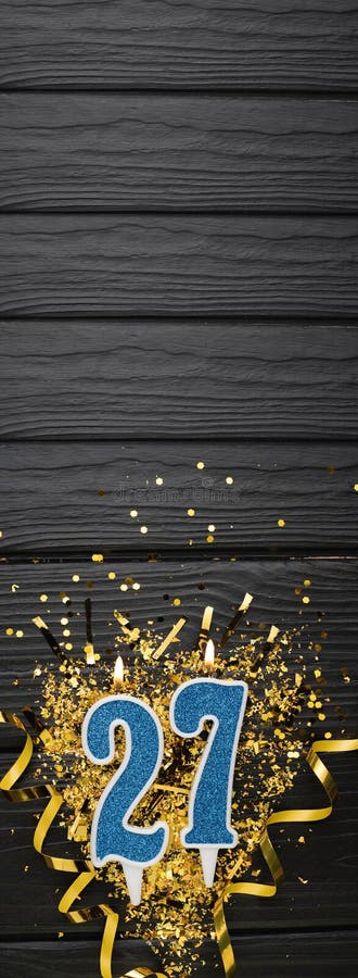 Number 27 Blue Celebration Candle And Gold Confetti On Dark Wooden