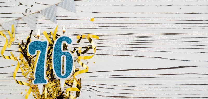 Number 76 Blue Celebration Candle On White Wooden Background With