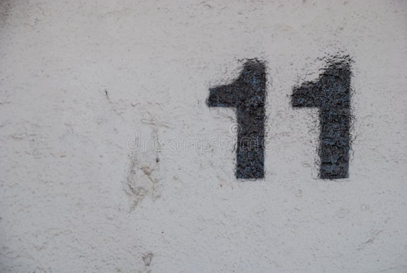 Number Eleven Painted in Black on a White Wall Stock Photo - Image of ...