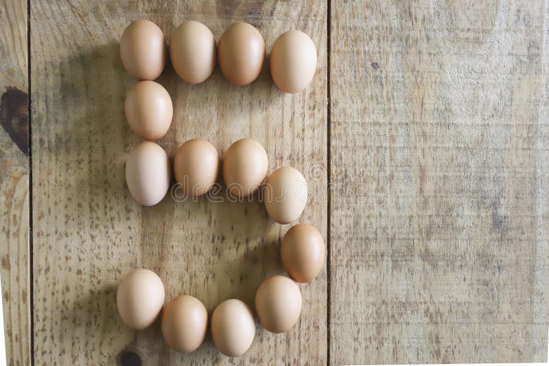 Number Five Written with Chicken Eggs, Arranged on a Rustic Pine Wood ...