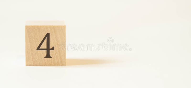 Number Four on a Wooden Cube with a White Background Stock Image ...