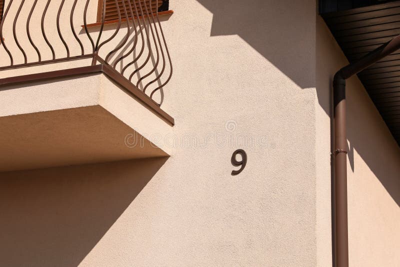 Number Nine on Beige House with Balcony Outdoors Stock Photo - Image of ...