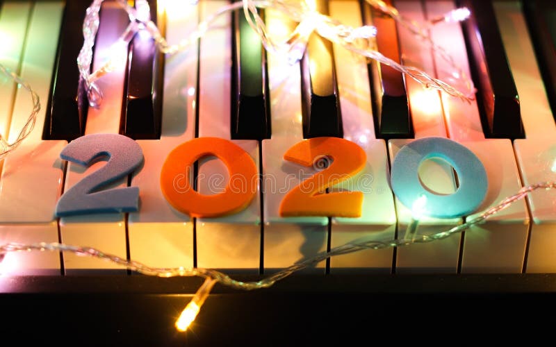 Number 2020 on Piano Keyboard with Glowing String Light Stock Image ...