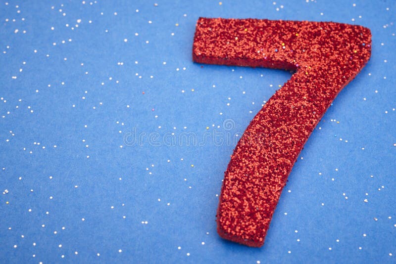 Number Seven Red Color Over a Blue Background. Anniversary Stock Photo ...