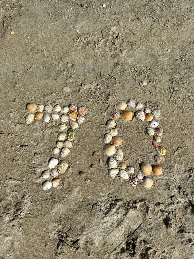 Number Seventy (70) Constructed from Seashells on the Beach Sand Stock ...