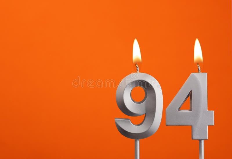Number 94 - Silver Anniversary Candle on Orange Background Stock ...