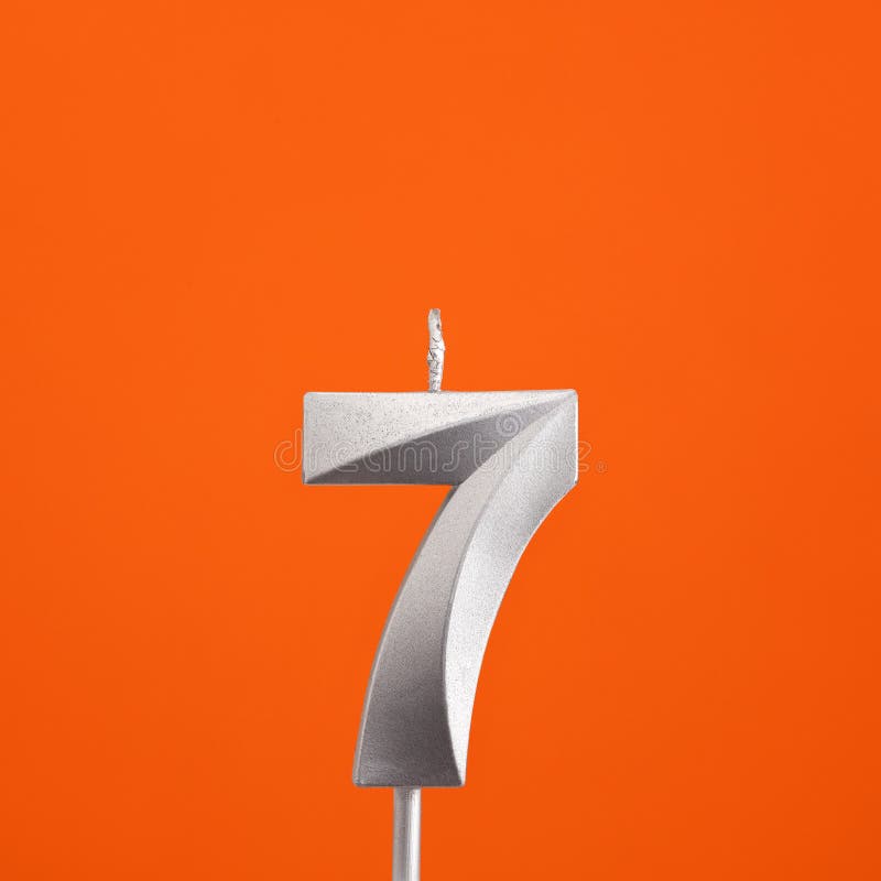 Number 7 - Silver Anniversary Candle on Orange Colored Background Stock ...