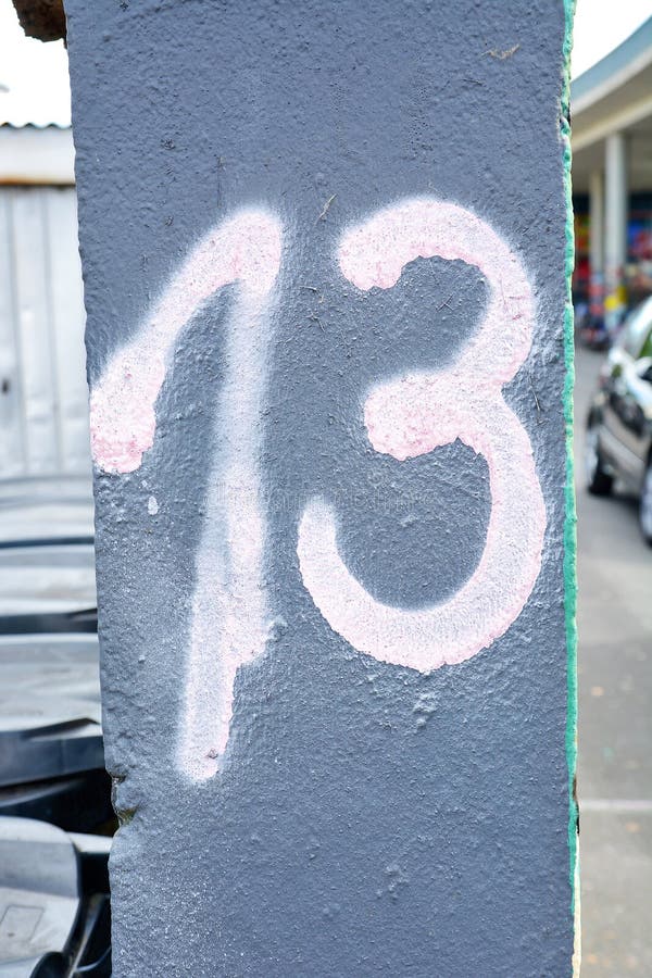 Number Thirteen, Painted in White on a Grey Pile Stock Photo - Image of ...