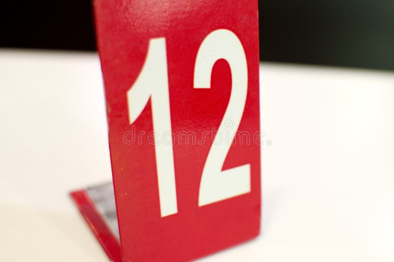 A Number Twelve Printed in White with Red Background Stock Image ...