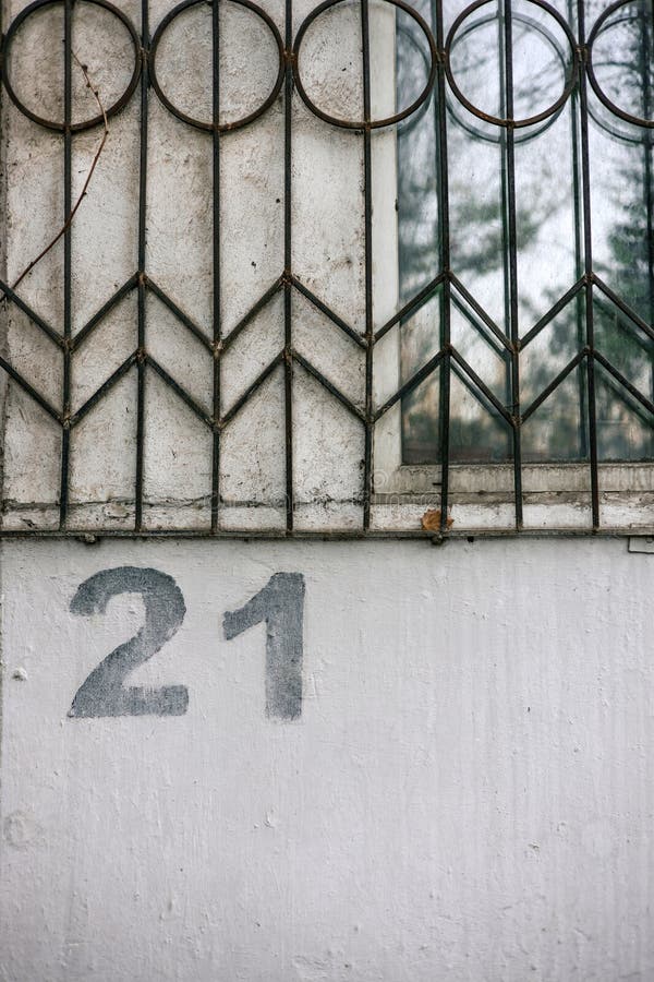 The Number Twenty One is Painted Using a Stencil on a Gray Wall Below a ...