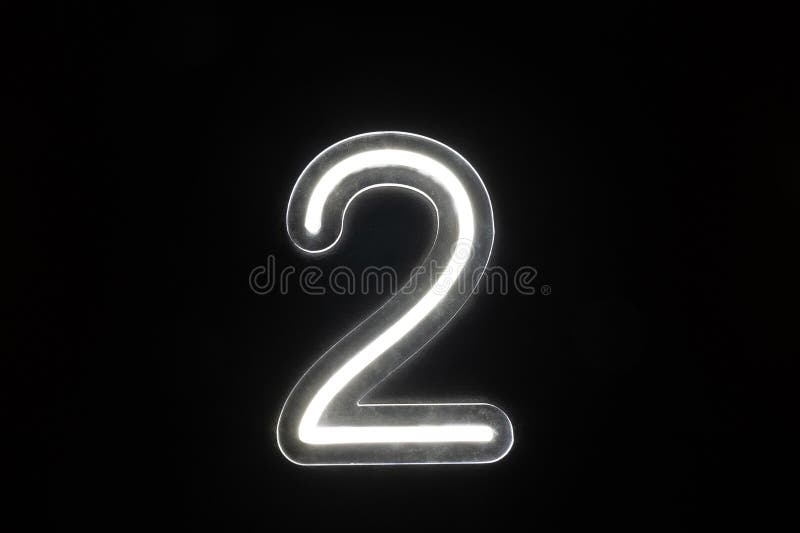 Number Two Glowing on the Dark Background. Close Up of Bright Number 2 ...