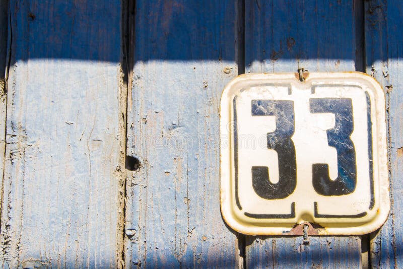 Number 33 on the Wooden Blue Crack Wall Stock Image - Image of board ...