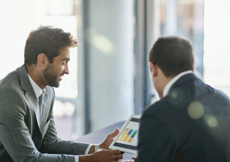 These Numbers are Fantastic. Two Colleagues Looking at a Graph on a ...