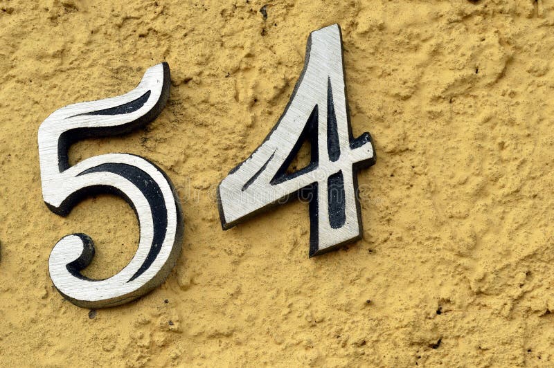 Numbers Five and Four in a Wall Stock Photo - Image of five, yellow ...