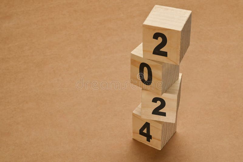 2024 Numbers on Wooden Cube Blocks Stack on Brown Background. New Year ...