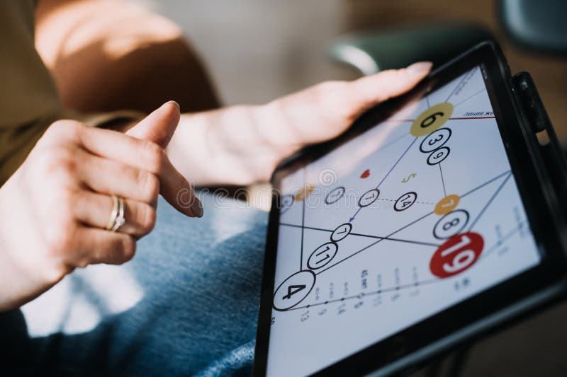 Numerologist Using a Tablet To Interpret a Digital Numerology Chart in ...