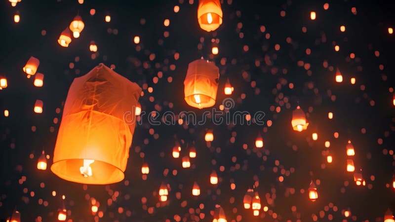 Numerous Lanterns Illuminate the Dark Sky As they Float through the Air ...