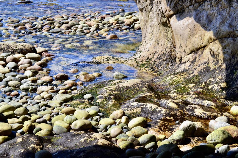 Bright Red Rocks Forming Barrier Along Charlottetown Harbour Stock ...