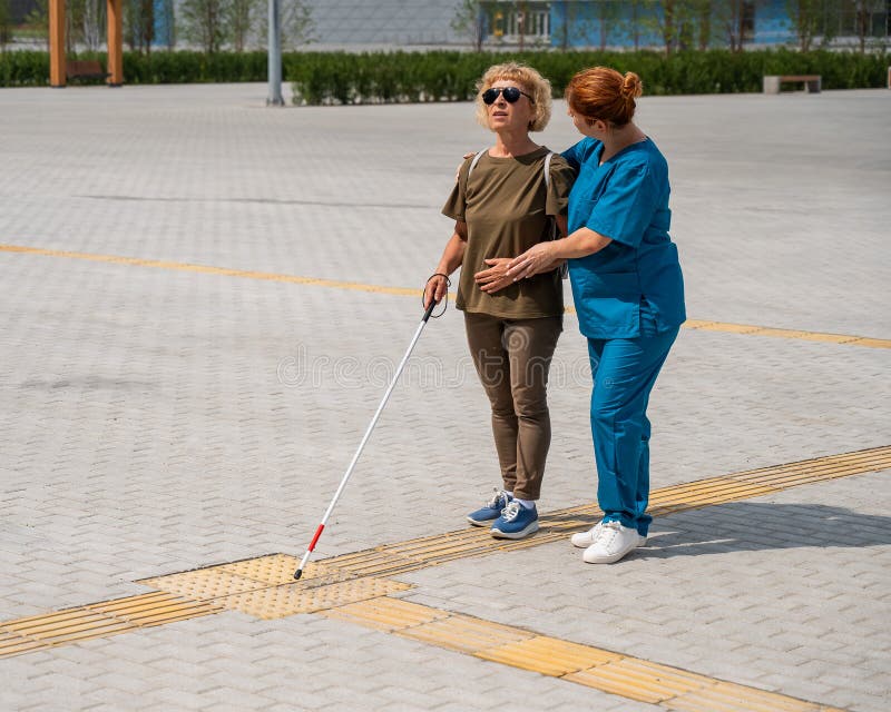 A Nurse Accompanies an Elderly Blind Woman on a Walk. Stock Photo ...