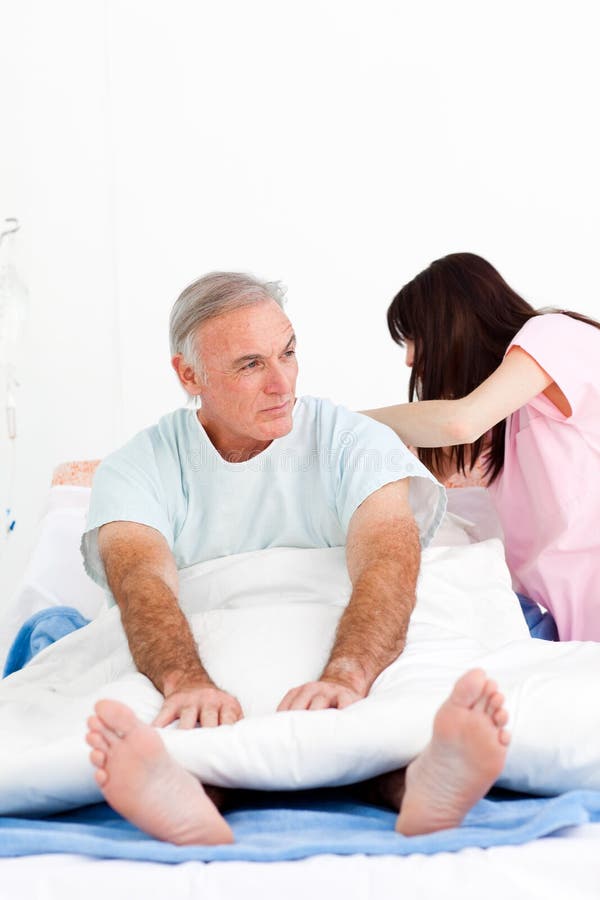 A Nurse Adjusting Pillows for a Senior Patient Stock Photo - Image of ...