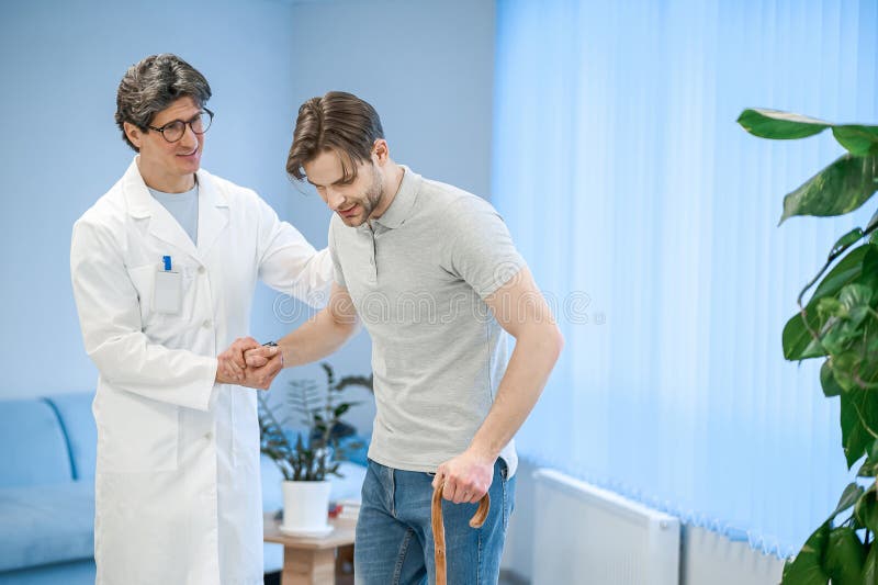 Nurse Assisting a Patient To Walk with a Stick Stock Image - Image of ...