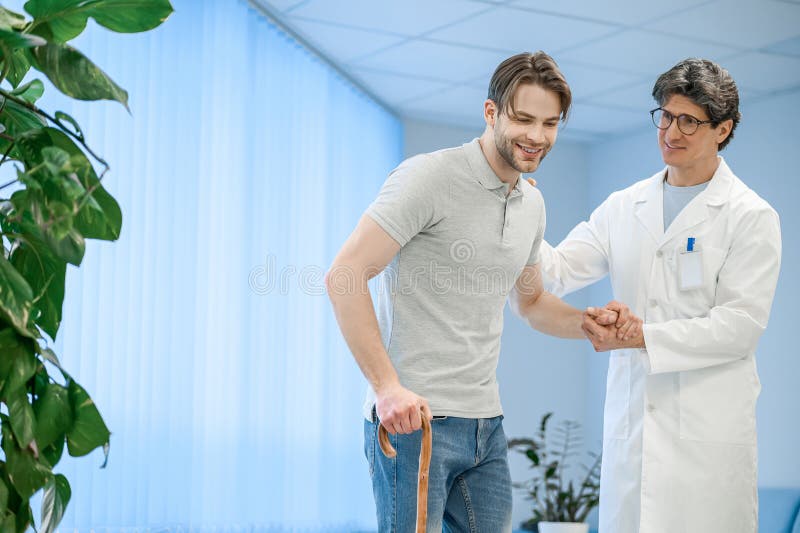 Nurse Assisting a Patient To Walk with a Stick Stock Image - Image of ...
