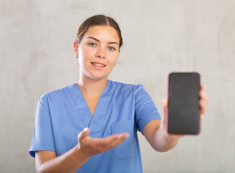Nurse In Blue Uniform Recommending Mobile Medical App Stretching Out