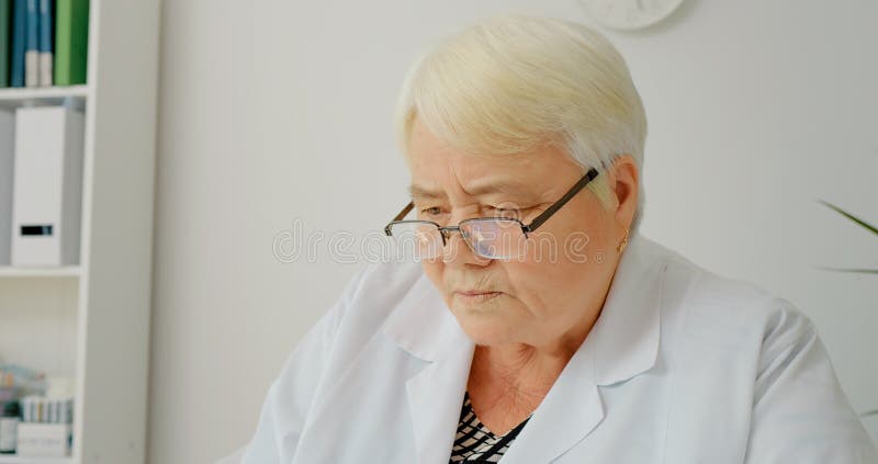 Nurse in Charge Working on Computer at Workplace. Stock Photo - Image ...