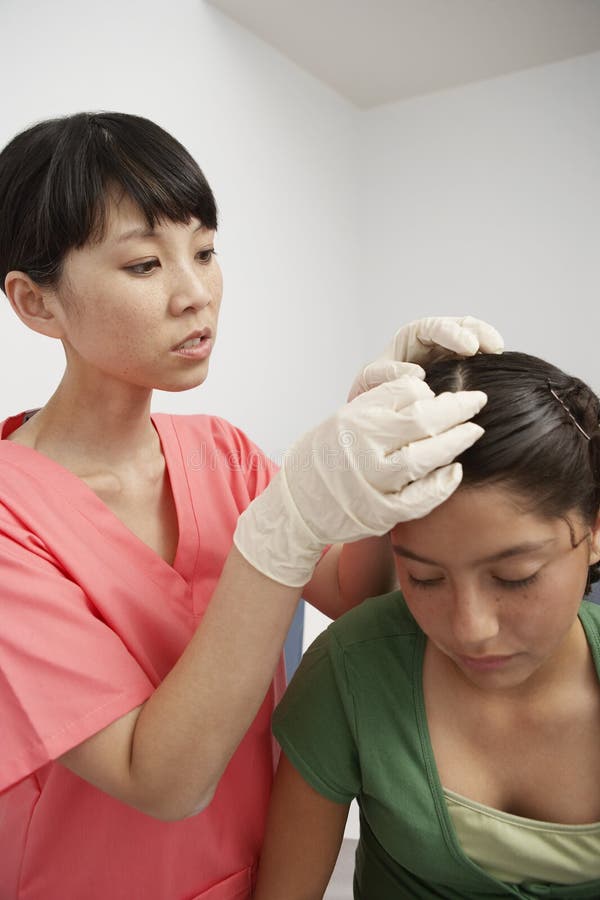 Nurse Checking Girl s Head stock photo. Image of chinese - 29664060