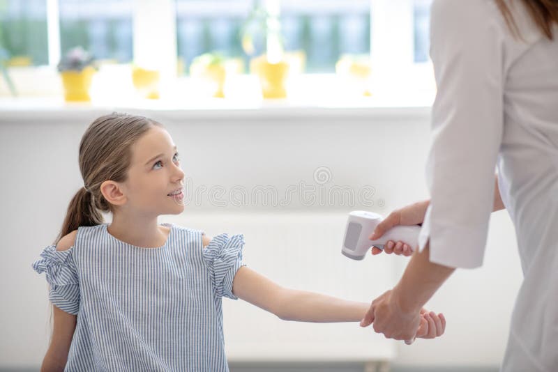 Nurse Checking the Girls Temperature Wth Digital Thermometer Stock ...
