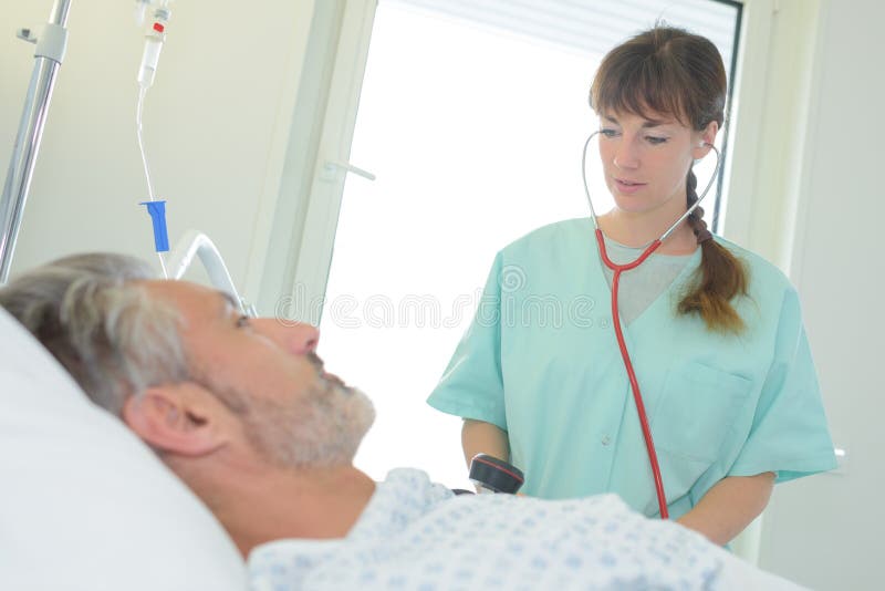 Nurse checking the patient stock photo. Image of lying - 122045536