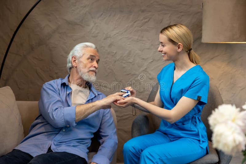 Nurse Checking Pulse or Level of Oxygen Using Oximeter of Senior Man ...