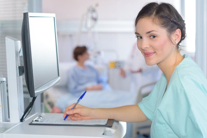 Nurse with Clipboard at Computer Stock Photo - Image of rounds ...