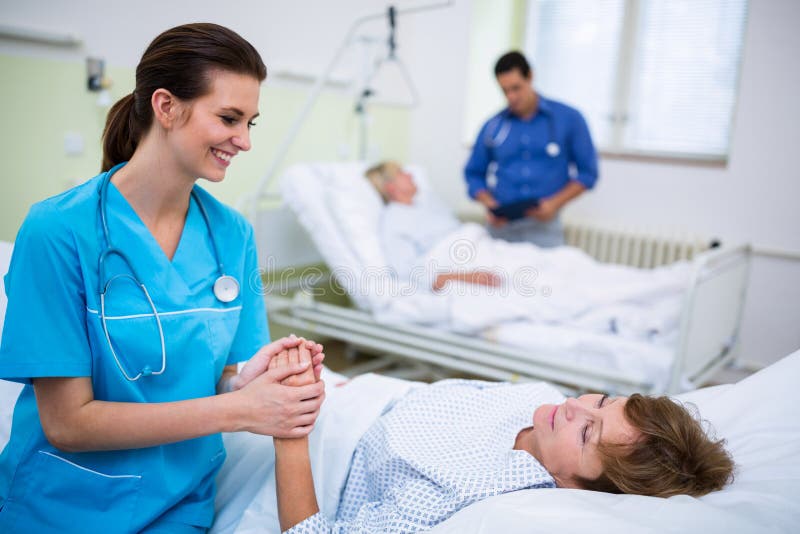 Nurse Consoling a Patient in Hospital Ward Stock Photo - Image of ...